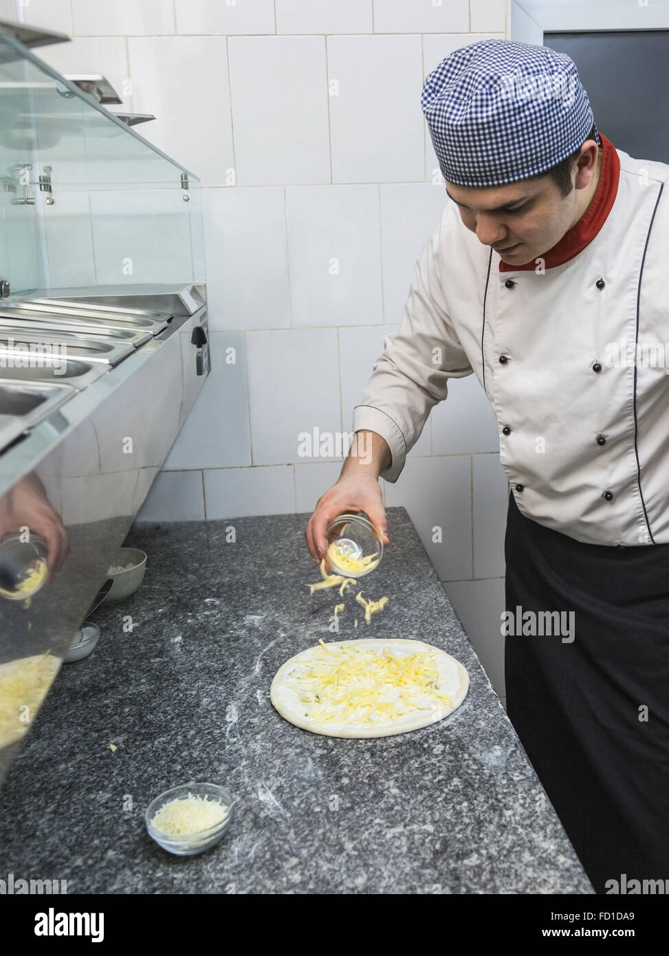 Chef cooking pizza in a kitchen of a restaurant Stock Photo - Alamy