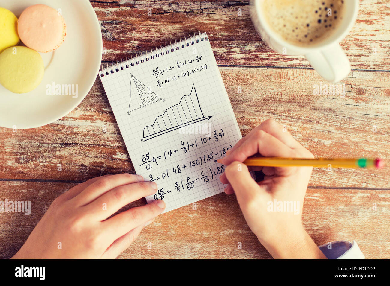 close up of hands writing mathematical equation Stock Photo - Alamy