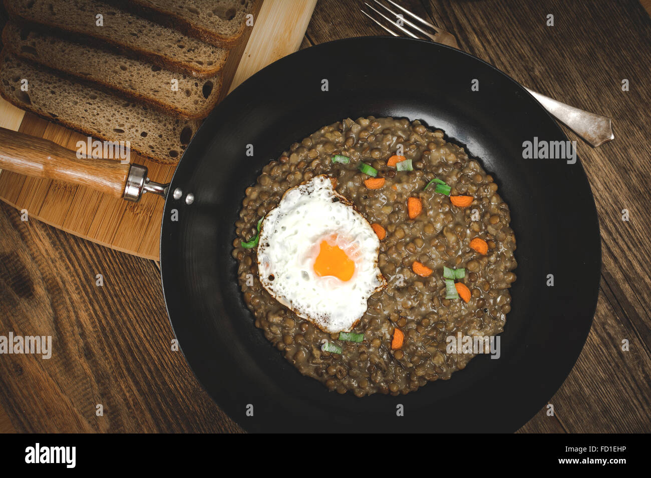 Traditional lentils or lens with egg and bread Stock Photo - Alamy