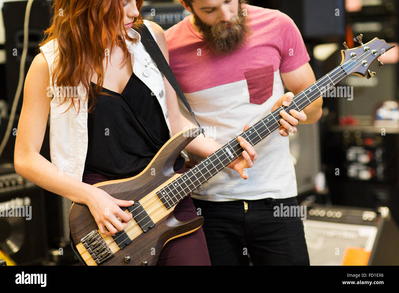 couple of musicians with guitar at music store Stock Photo - Alamy