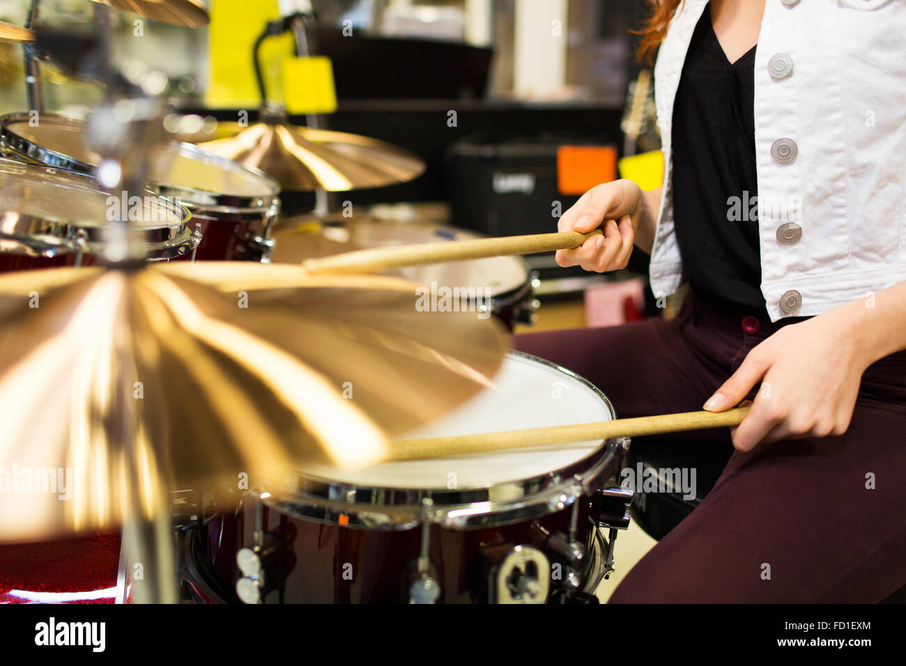 close up of woman playing cymbals at music store Stock Photo - Alamy