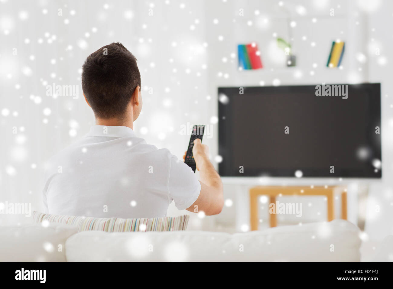 man watching tv and changing channels at home Stock Photo - Alamy
