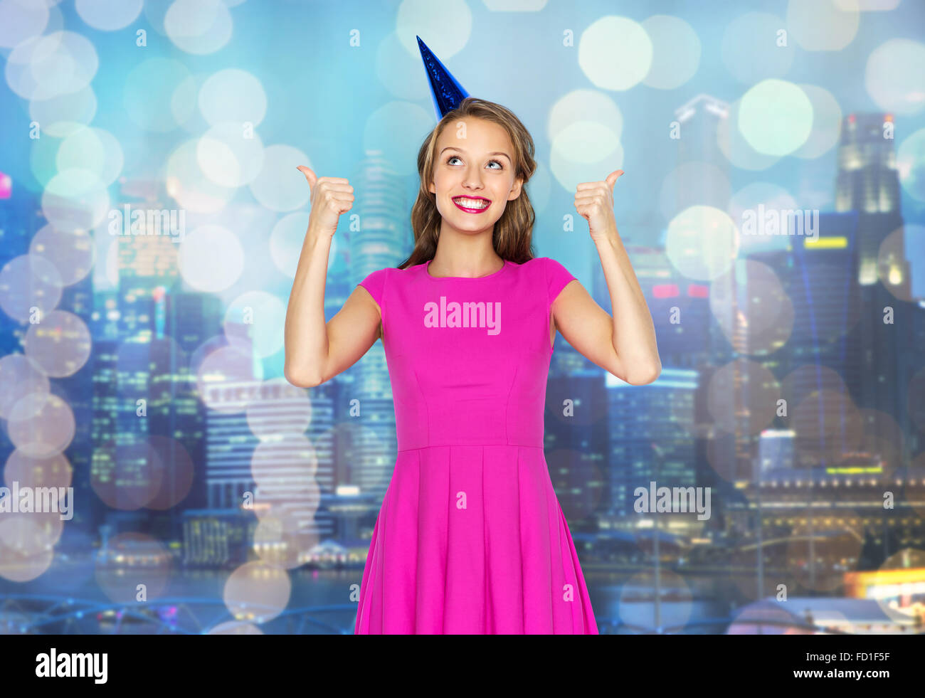 happy young woman or teen girl in party cap Stock Photo - Alamy