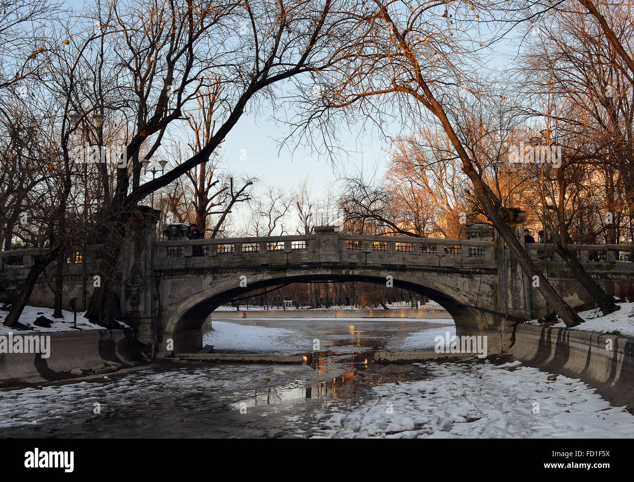 Stone bridge in snow, Cismigiu Park, Bucharest, Romania Stock Photo - Alamy