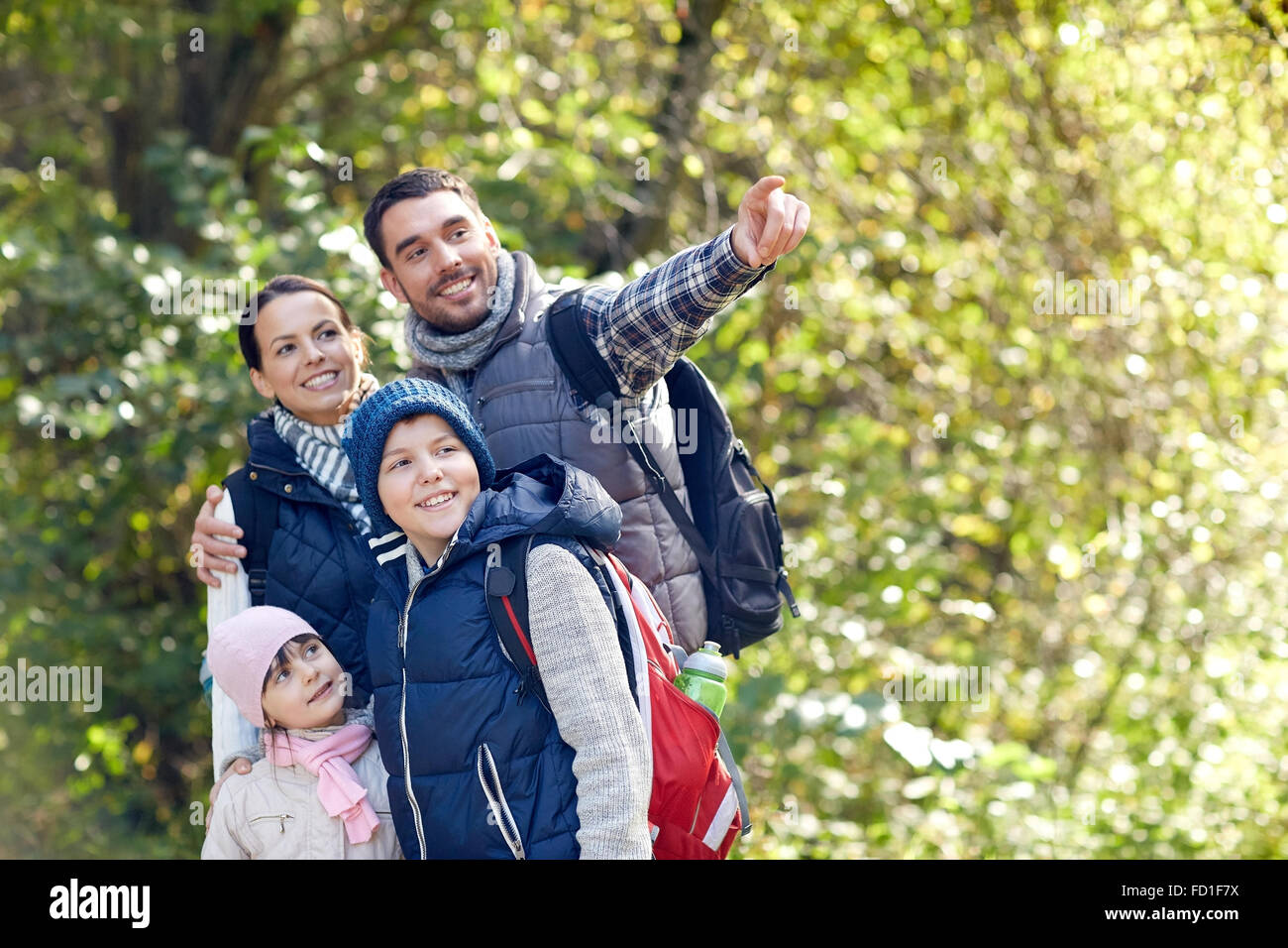 happy family with backpacks hiking Stock Photo - Alamy