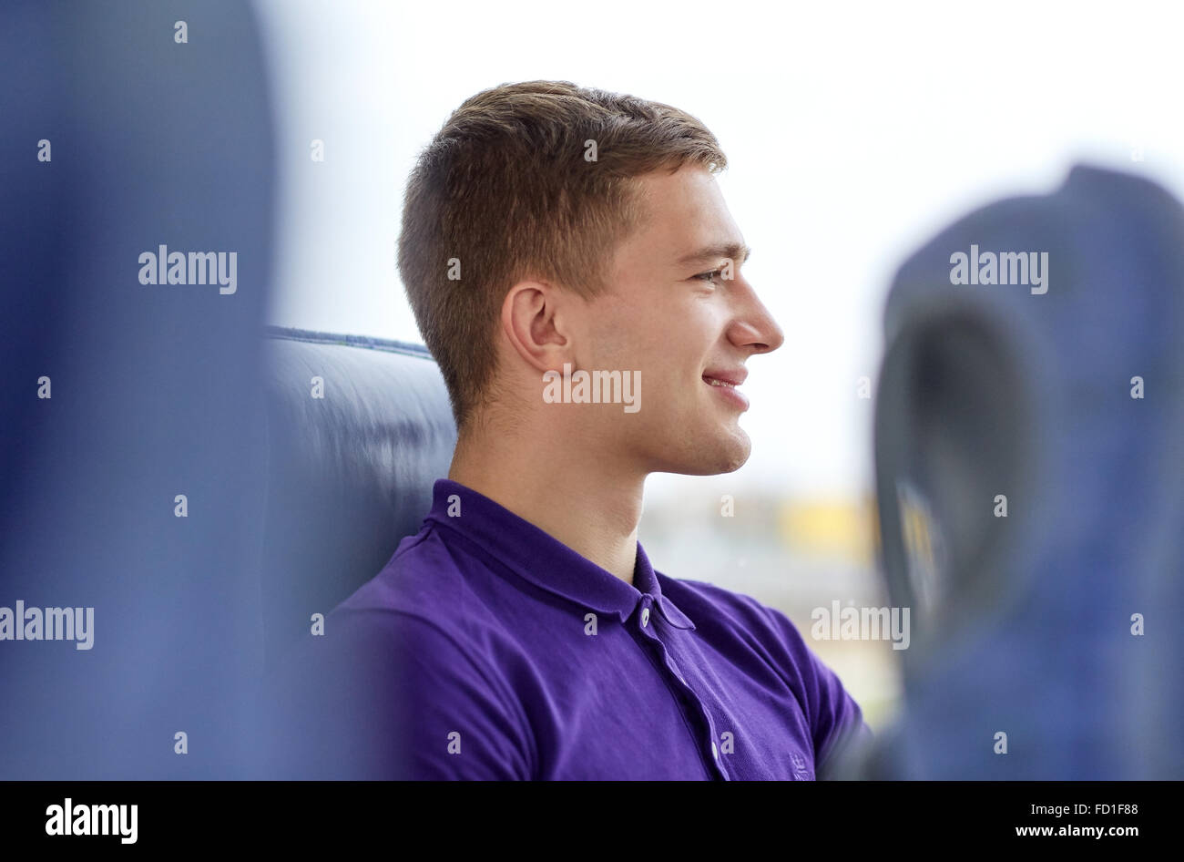 happy young man sitting in travel bus Stock Photo - Alamy