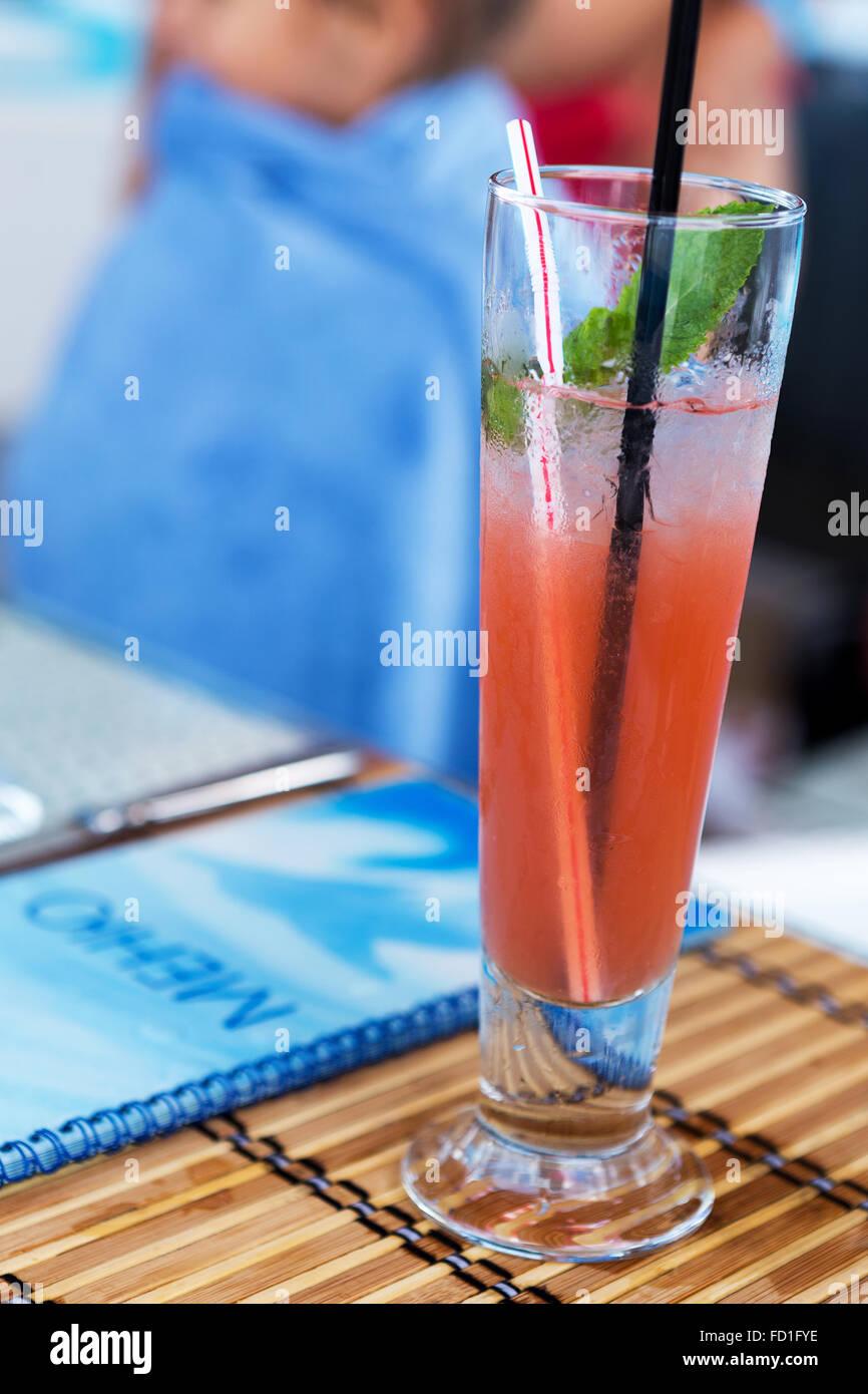 Light alcoholic drink with watermelon juice and ice in the glass. Blur ...