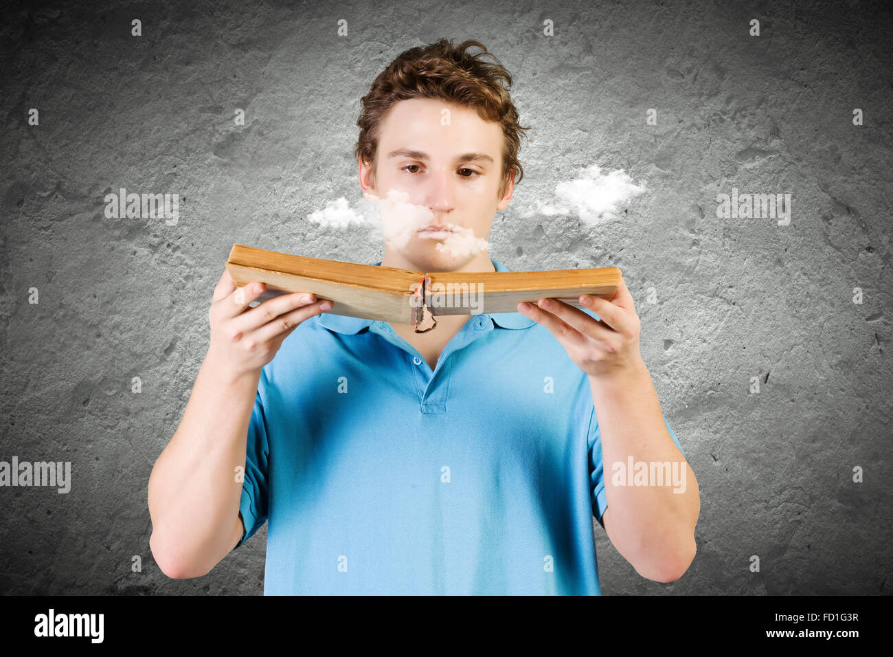 Young man in casual holding opened book Stock Photo - Alamy