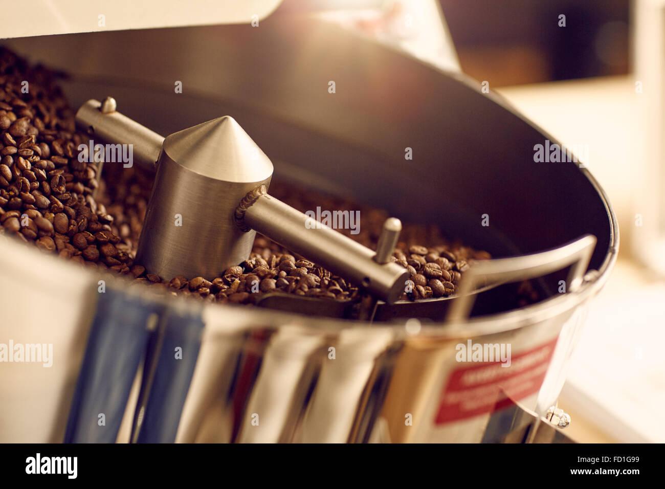 Coffee beans being roasted in a modern roastery Stock Photo - Alamy