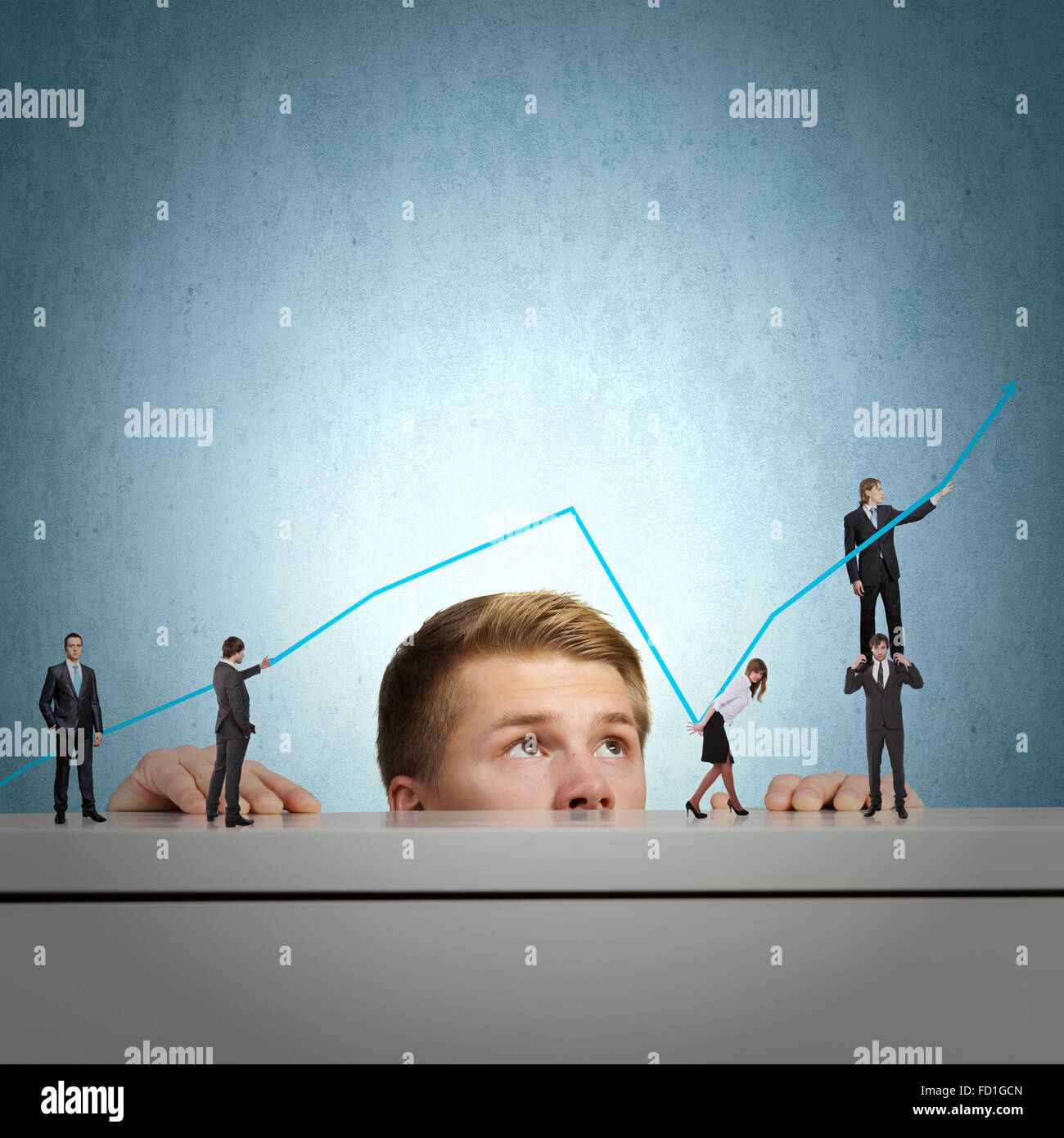Businessman looking from under the table at businessteam Stock Photo ...