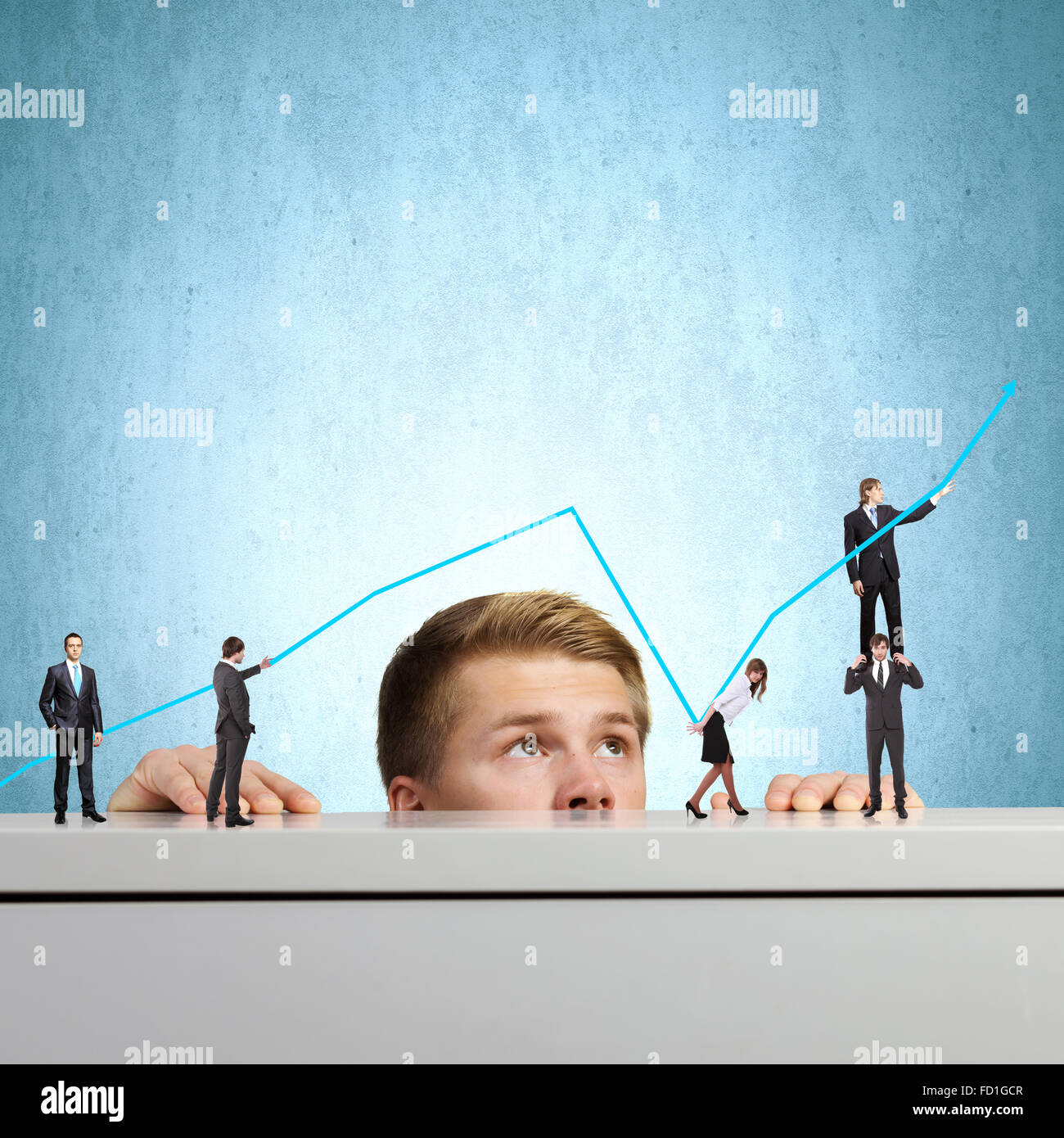 Businessman looking from under the table at businessteam Stock Photo ...