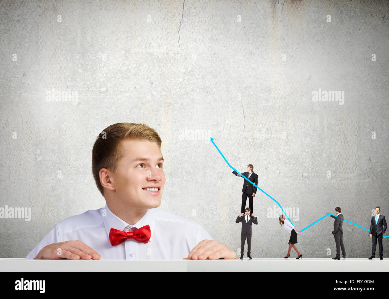 Businessman looking from under the table at businessteam Stock Photo ...