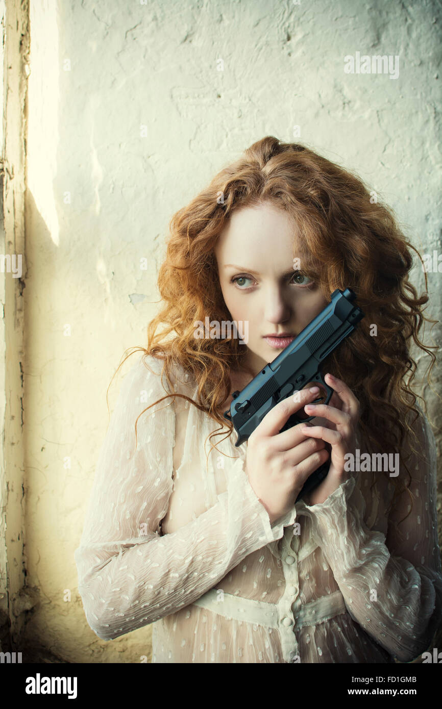 Girl holding guns hi-res stock photography and images - Alamy