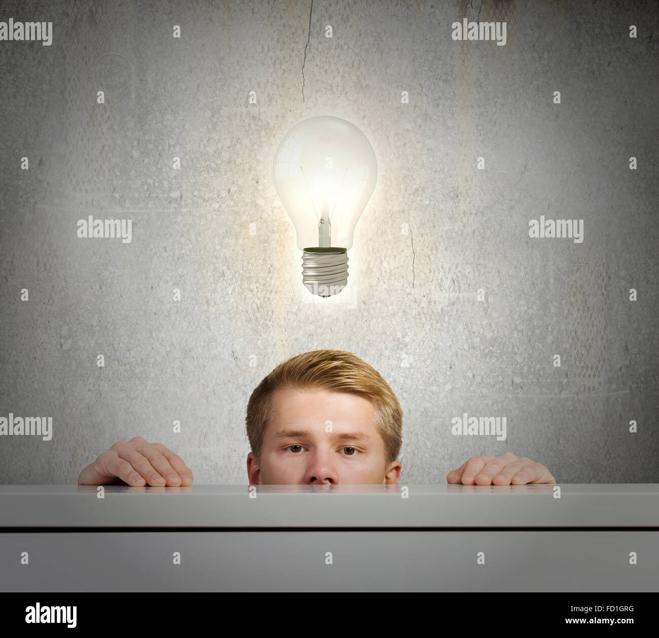 Half of face of young man looking out out from under the table Stock ...