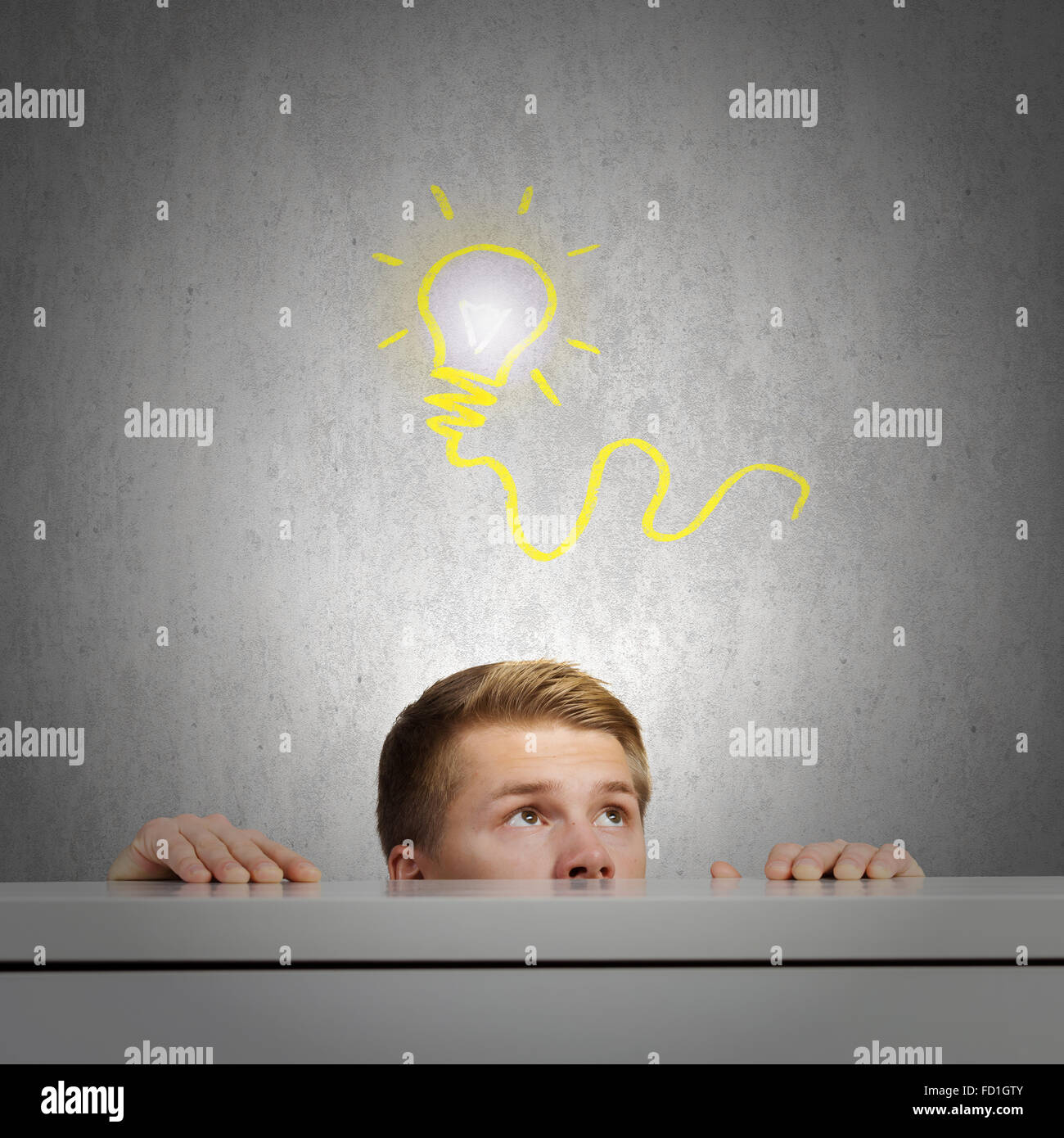 Half of face of young man looking out out from under the table Stock ...