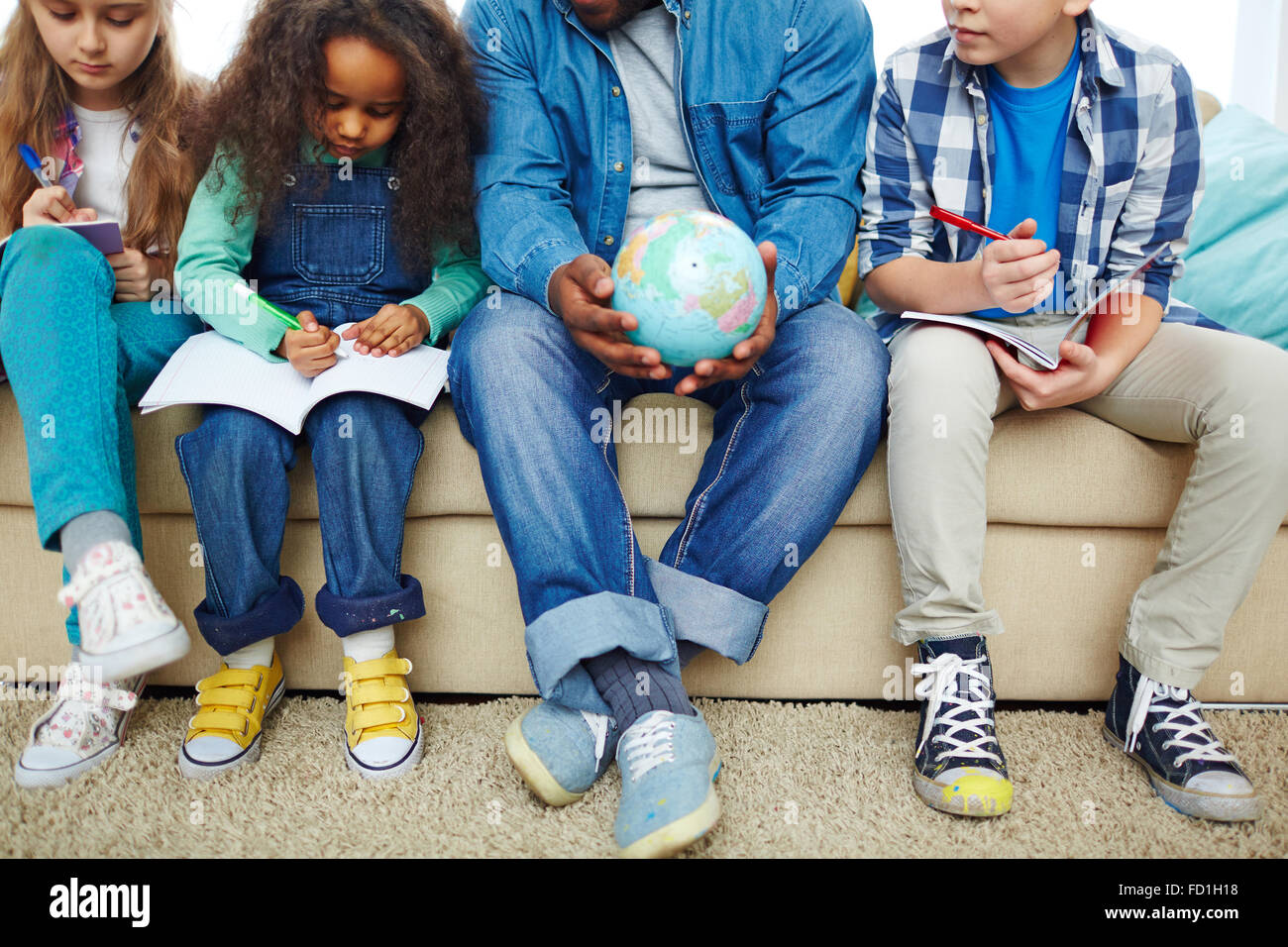 Group of pupils studying with their teacher Stock Photo - Alamy