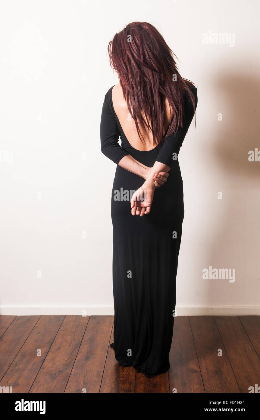 Rear view of a woman in black dress Stock Photo - Alamy