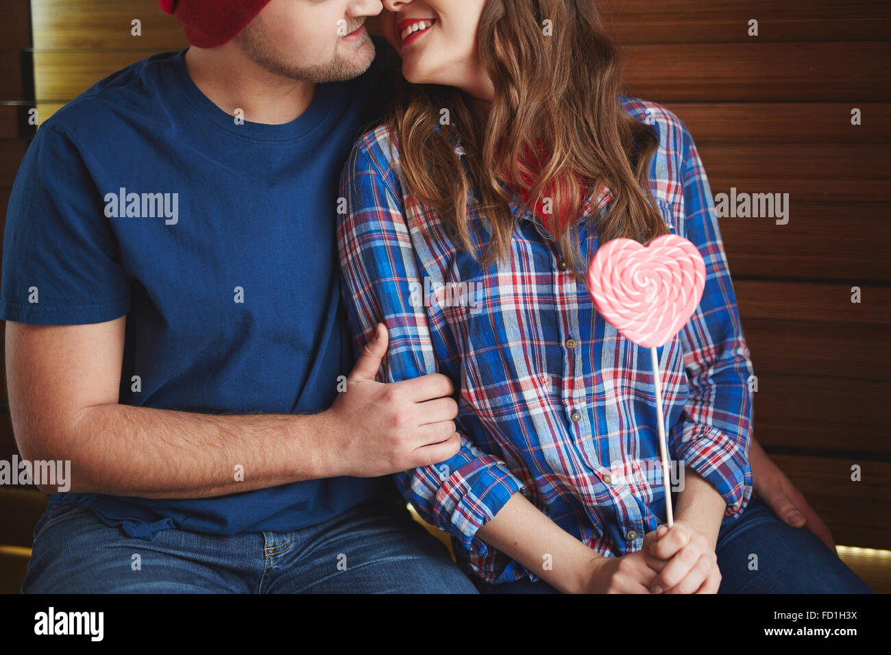 Amorous woman with heartshaped candy flirting with young man Stock ...