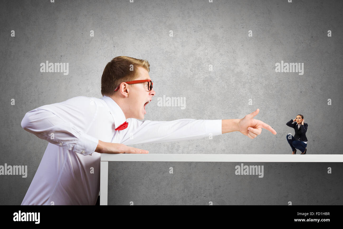 Angry businessman screaming at miniature of woman colleague Stock Photo ...