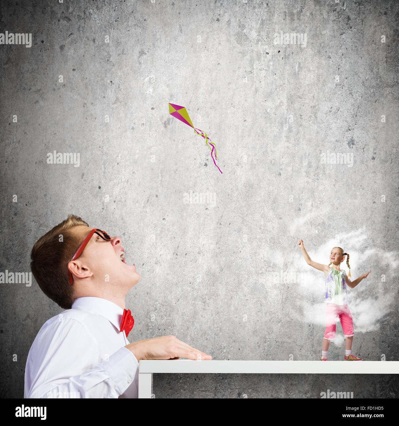 Young man looking out from under the table Stock Photo - Alamy