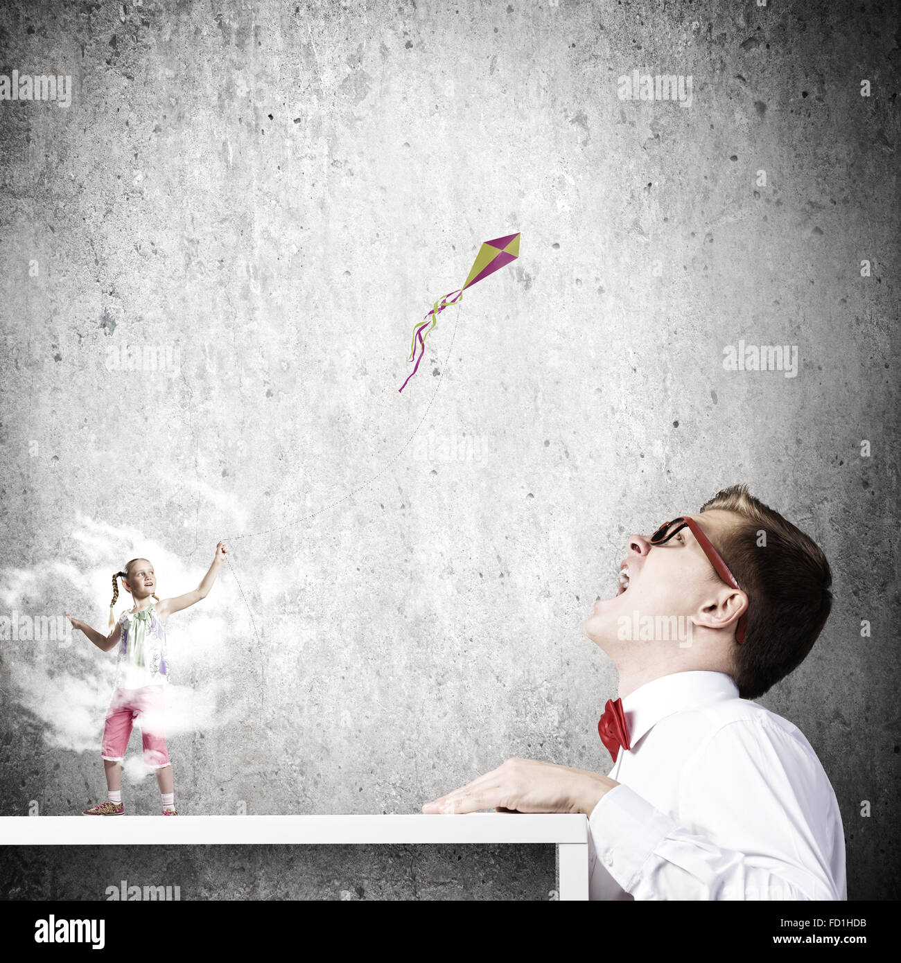 Young man looking out from under the table Stock Photo - Alamy