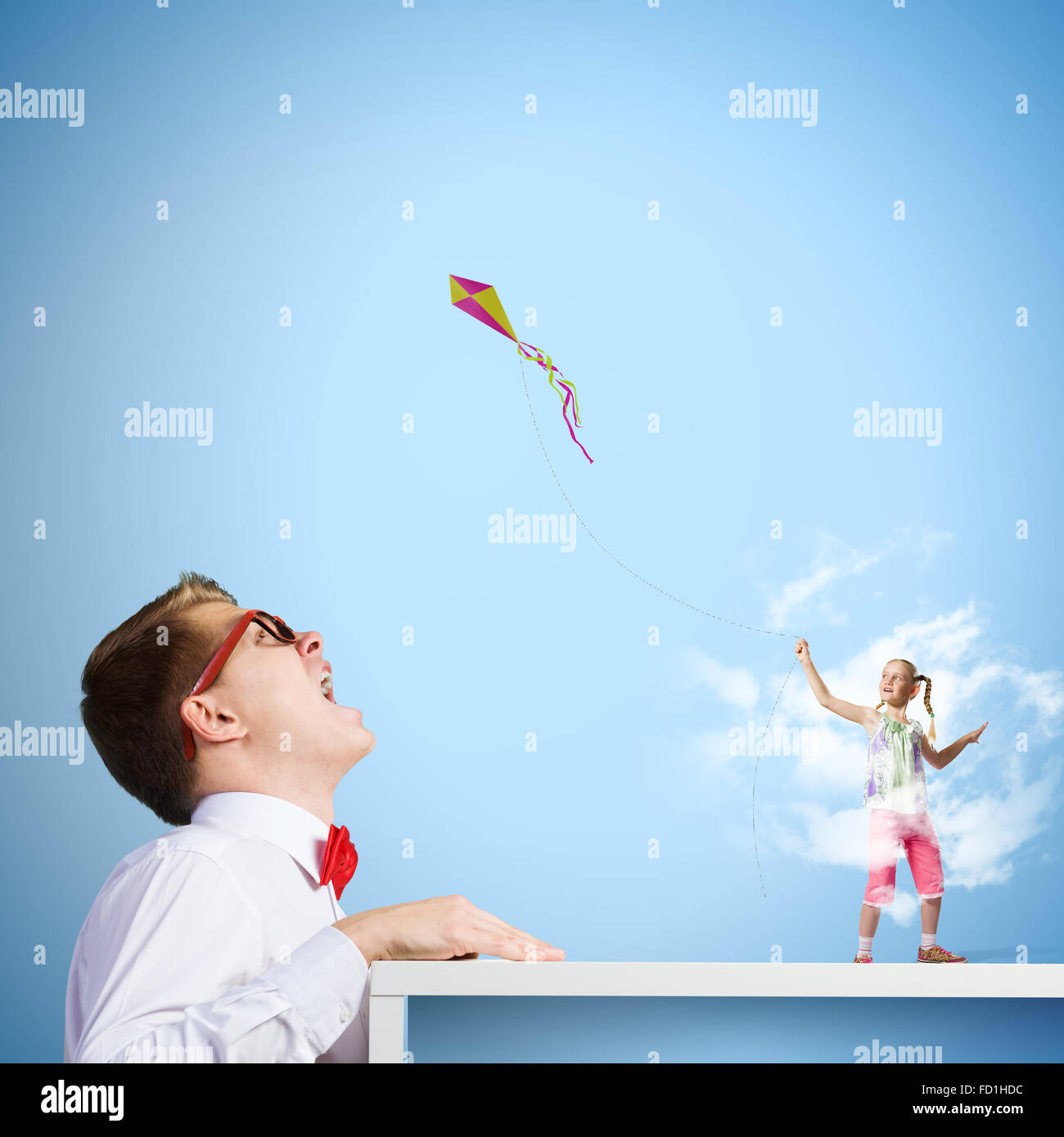 Young man looking out from under the table Stock Photo - Alamy