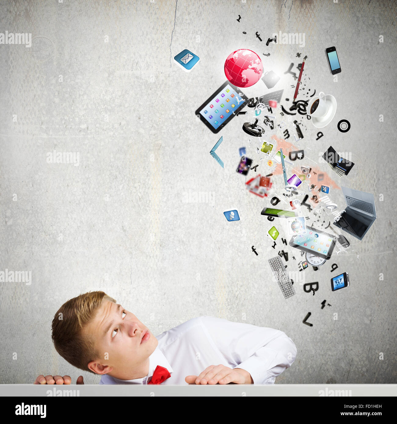 Young man looking out from under the table Stock Photo - Alamy