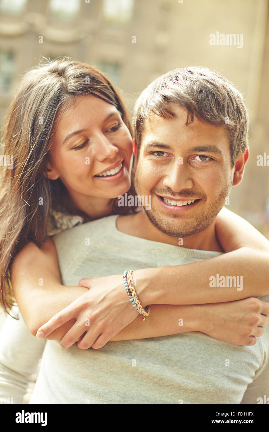 Amorous young woman embracing her boyfriend outdoors Stock Photo - Alamy