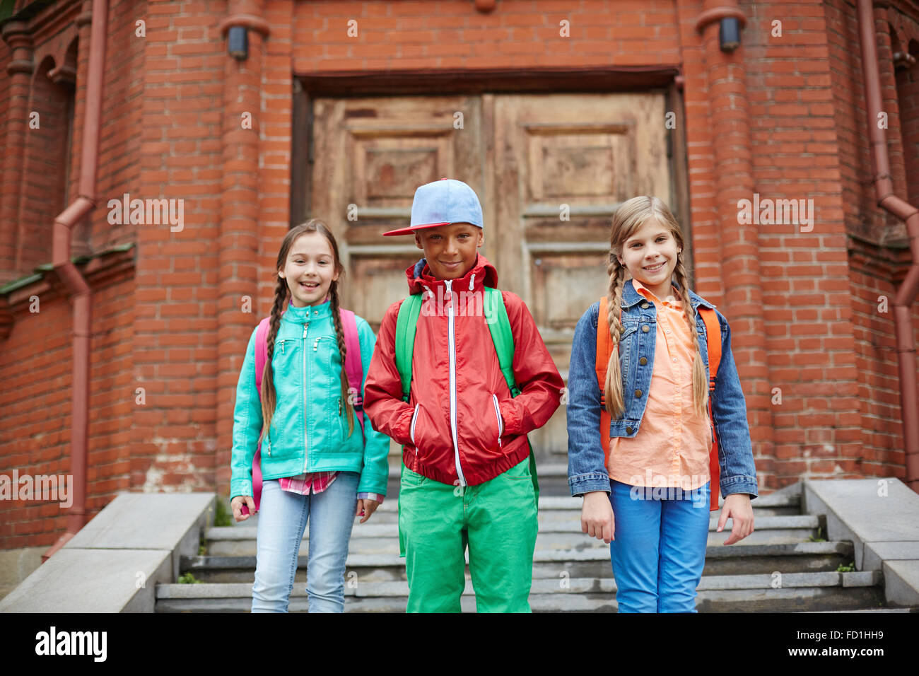 Happy schoolkids with backpacks leaving school Stock Photo - Alamy Happy schoolkids with backpacks leaving school Stock Photo - Alamy
