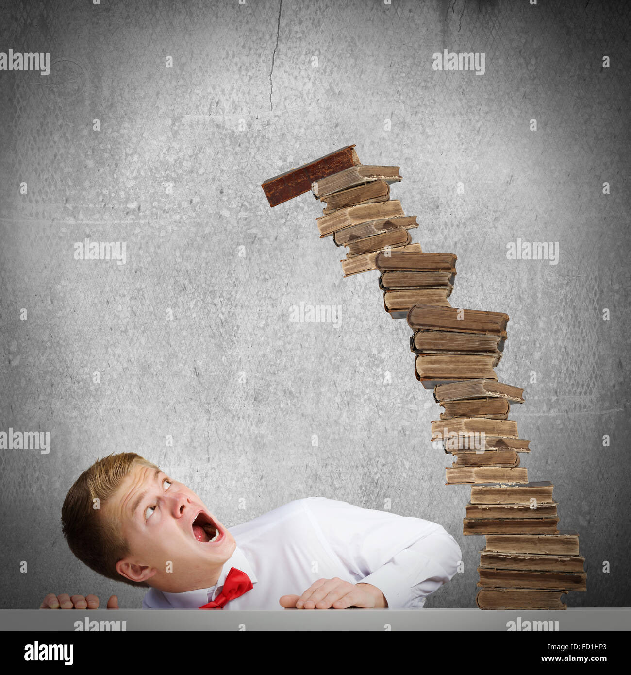 Young handsome businessman and falling pile of books Stock Photo - Alamy