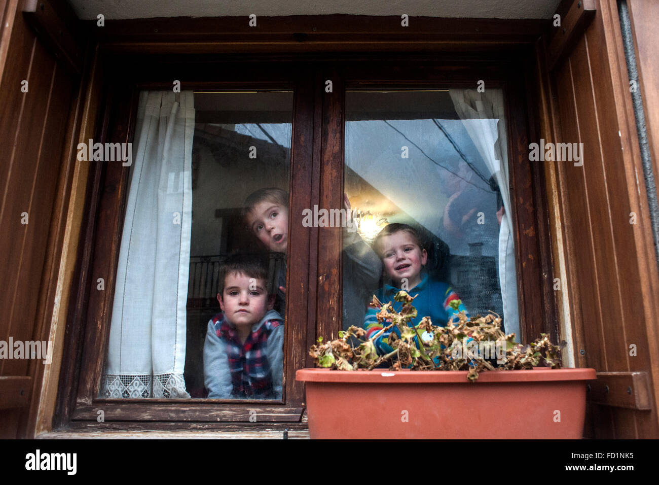 some children watching from the window of his house Unanua carnival in ...