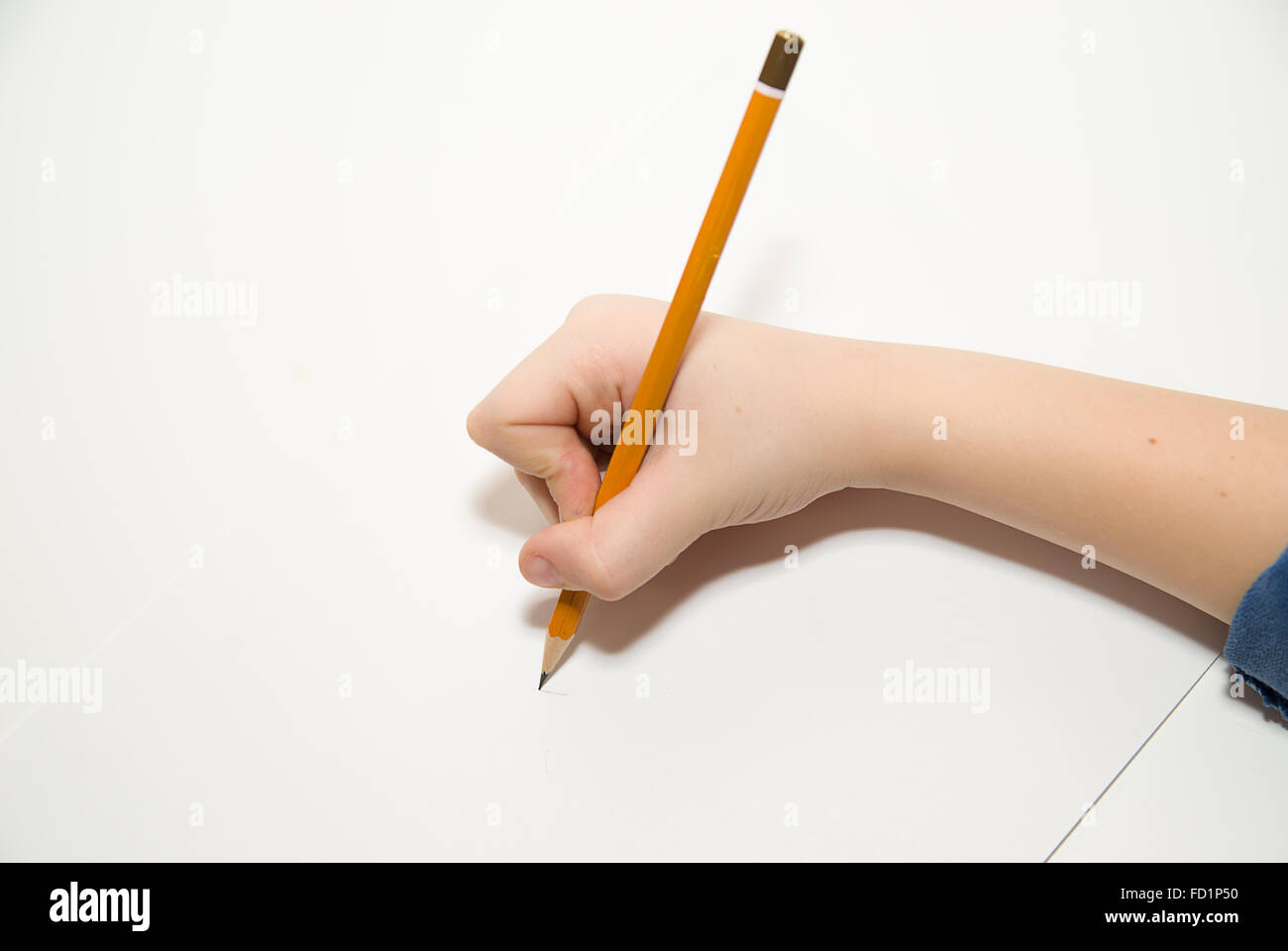 Kid's right hand holding a pencil on a white Stock Photo - Alamy