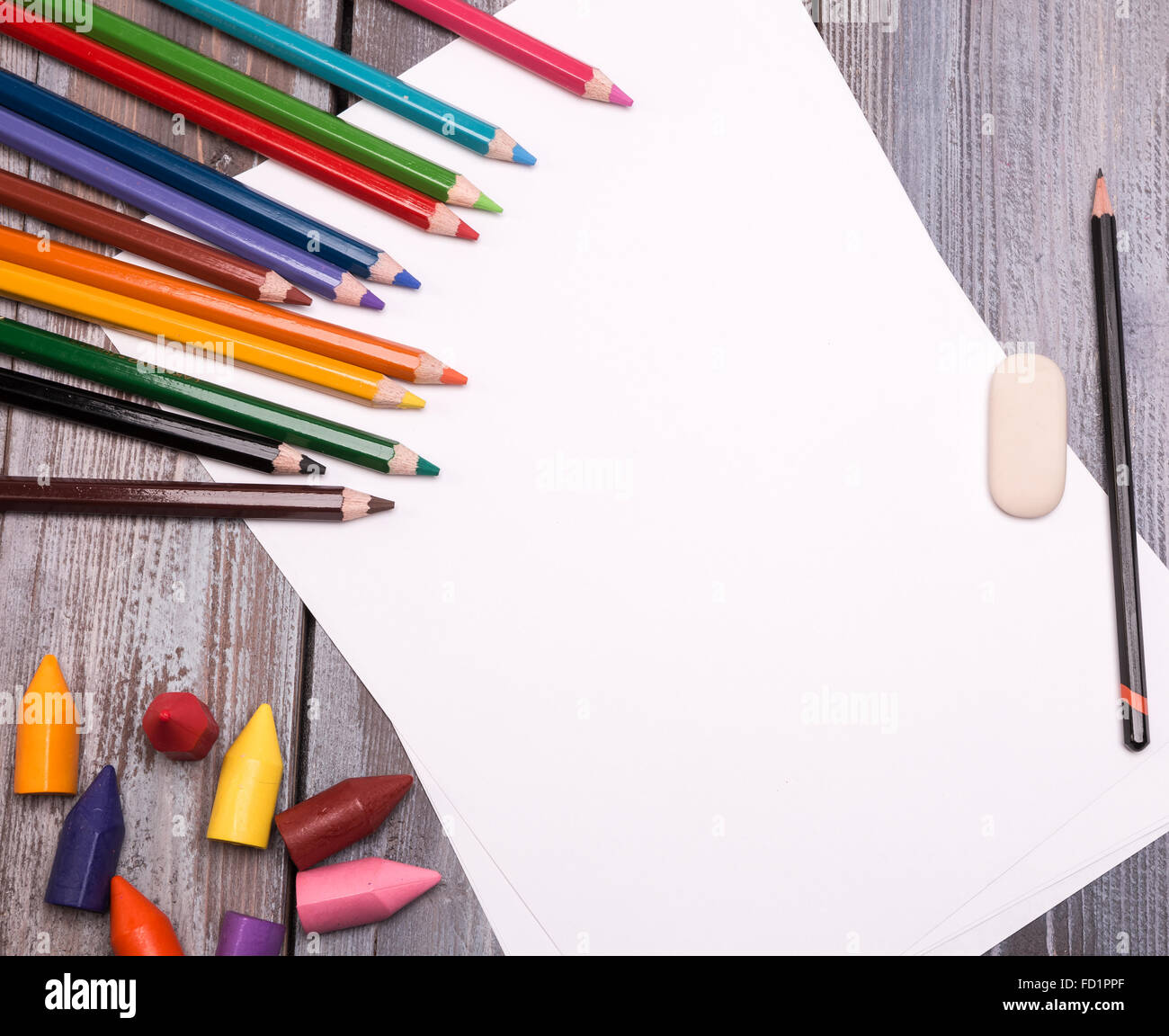 many colorful pencils and others drawing tools on a clear white paper ...