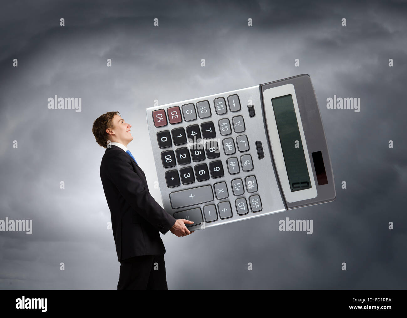 Young businessman carrying huge calculator in hands Stock Photo - Alamy