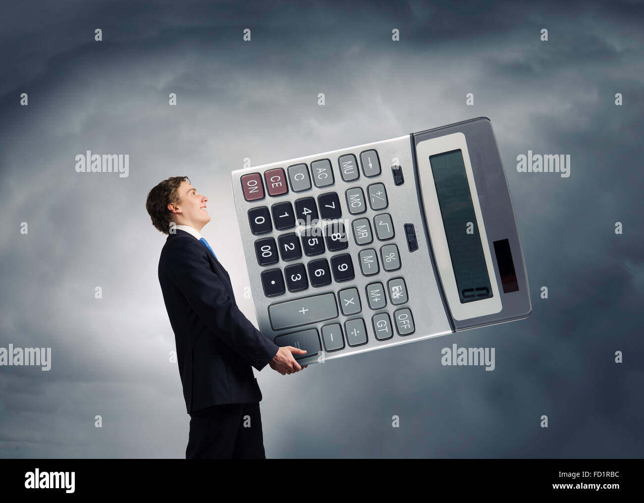 Young businessman carrying huge calculator in hands Stock Photo - Alamy