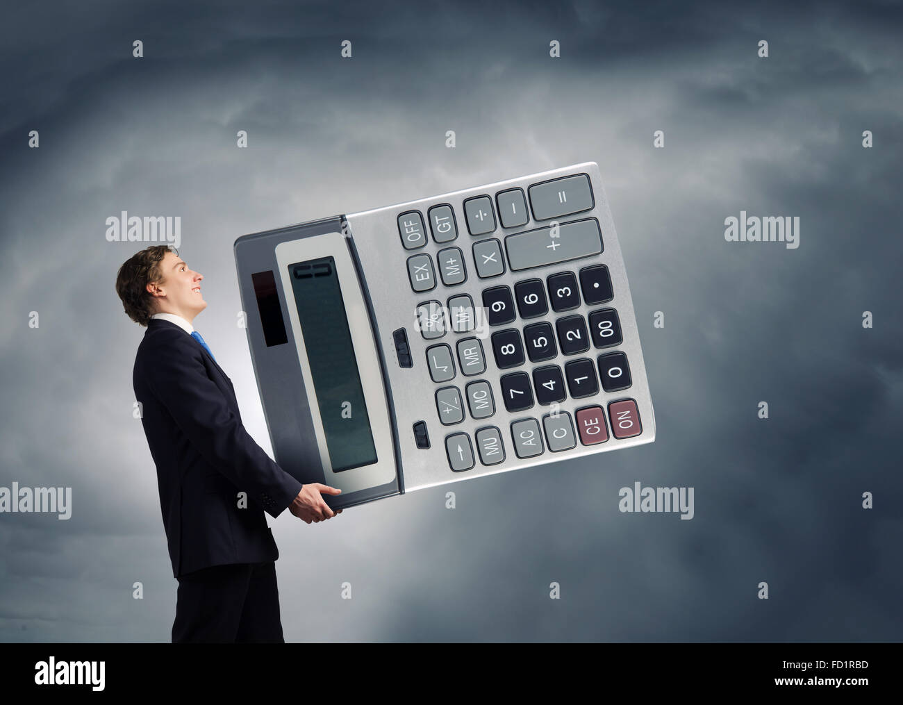 Young businessman carrying huge calculator in hands Stock Photo - Alamy