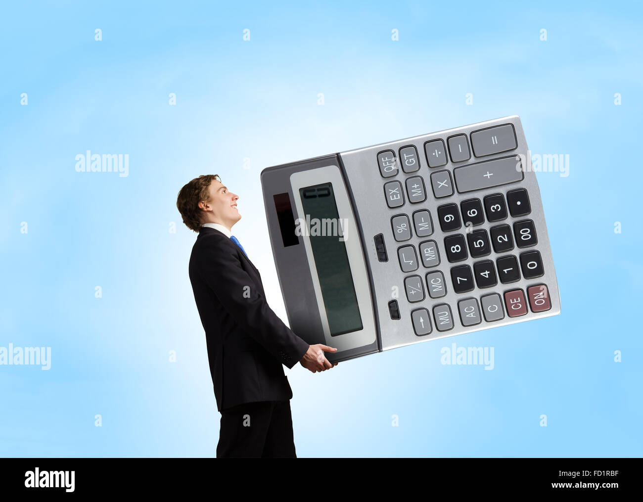 Young businessman carrying huge calculator in hands Stock Photo - Alamy