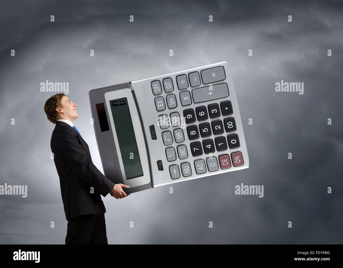Young businessman carrying huge calculator in hands Stock Photo - Alamy