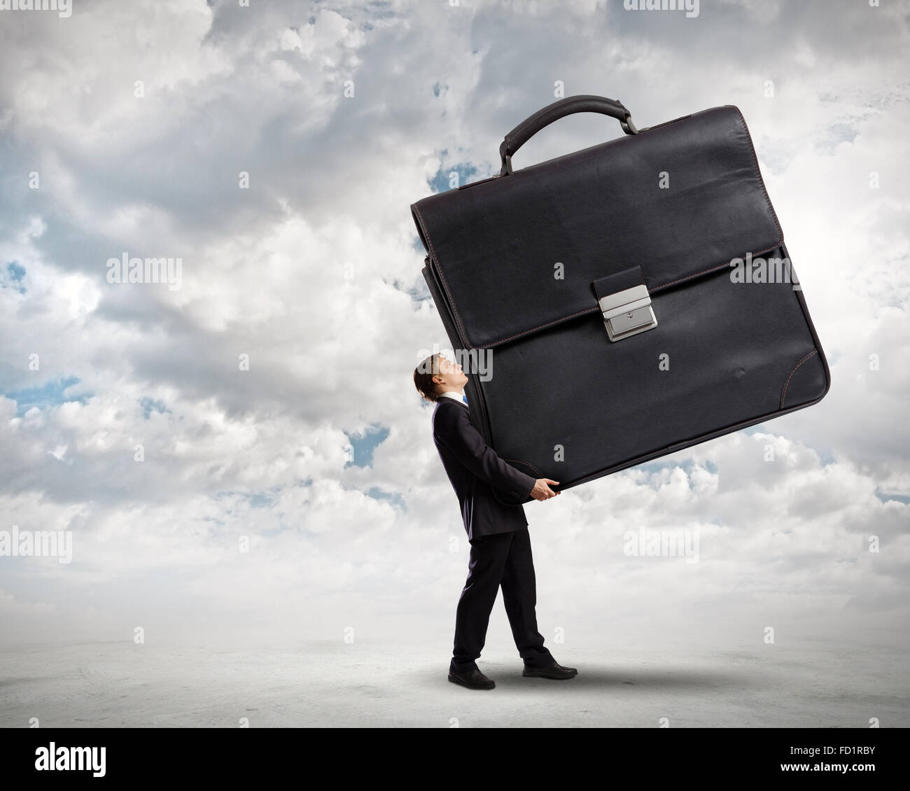 Young determined businessman carrying big heavy suitcase Stock Photo ...