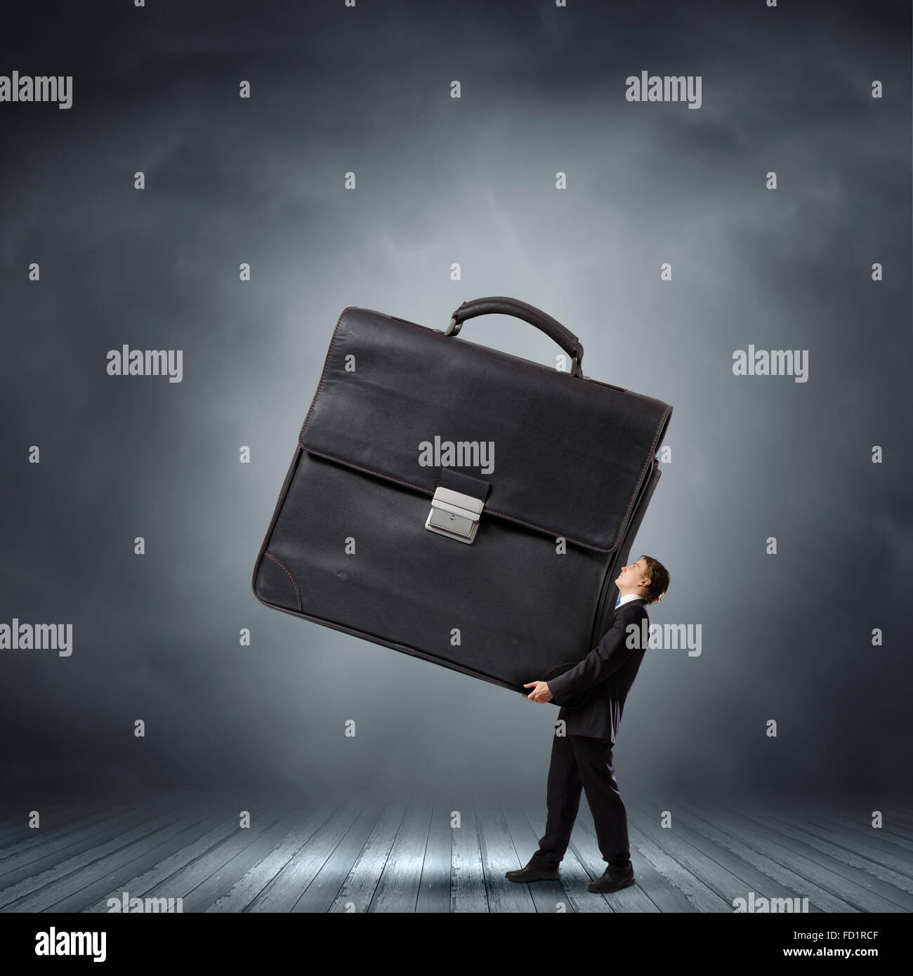 Young determined businessman carrying big heavy suitcase Stock Photo ...