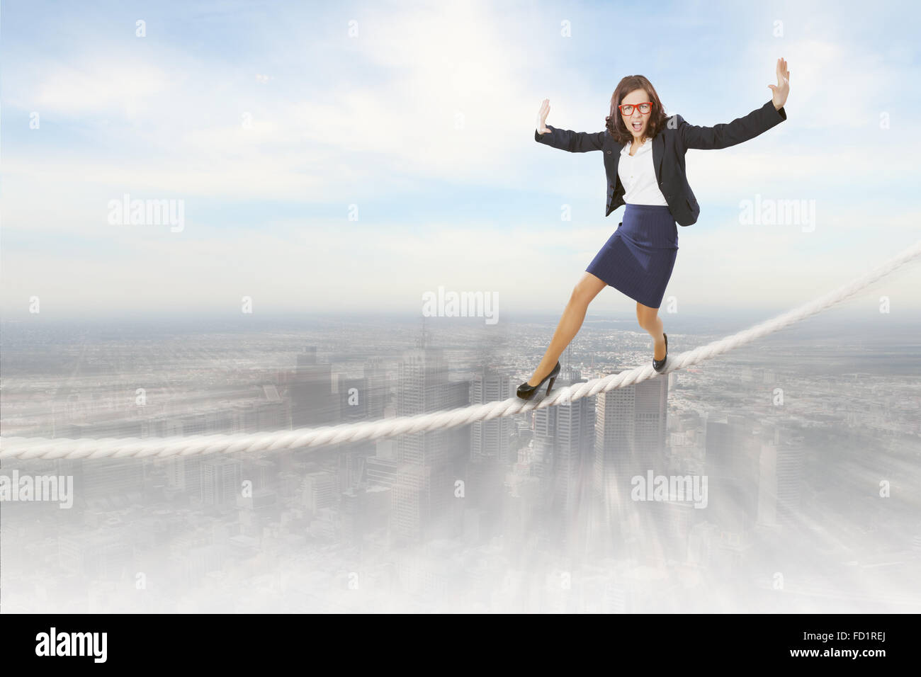 Young attractive businesswoman balancing on rope high in sky Stock ...