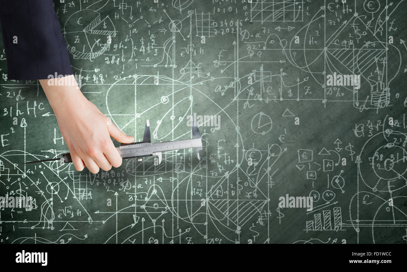 Close up of business person hand measuring bulb Stock Photo - Alamy