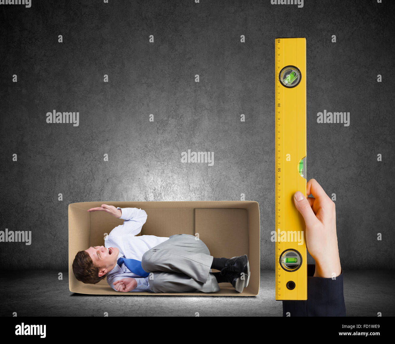 Close up of business person hand measuring man in carton box Stock ...