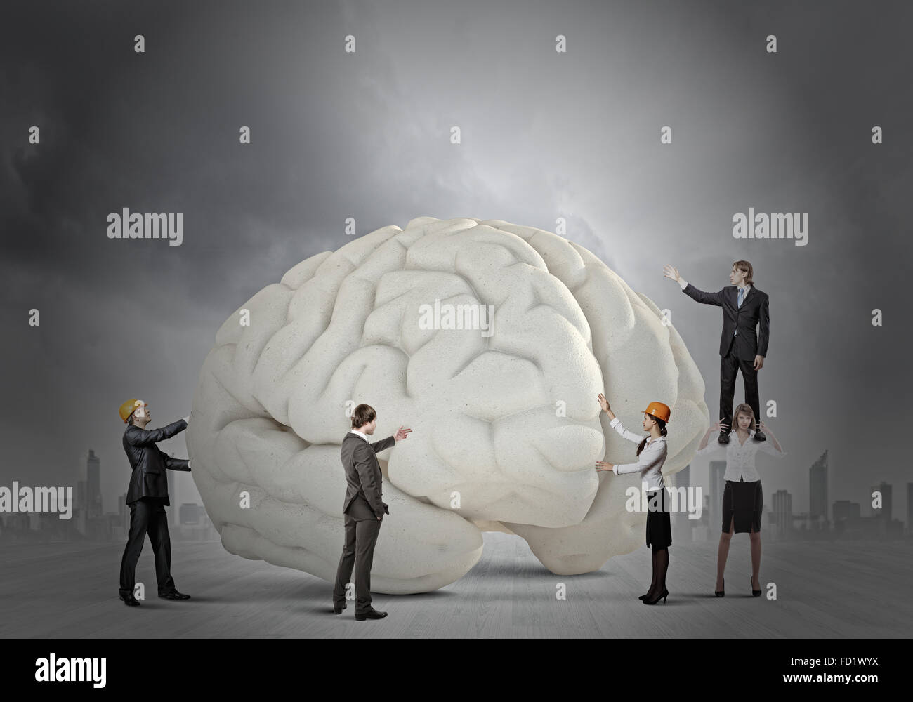 Huge human brain and many little businesspeople around Stock Photo - Alamy