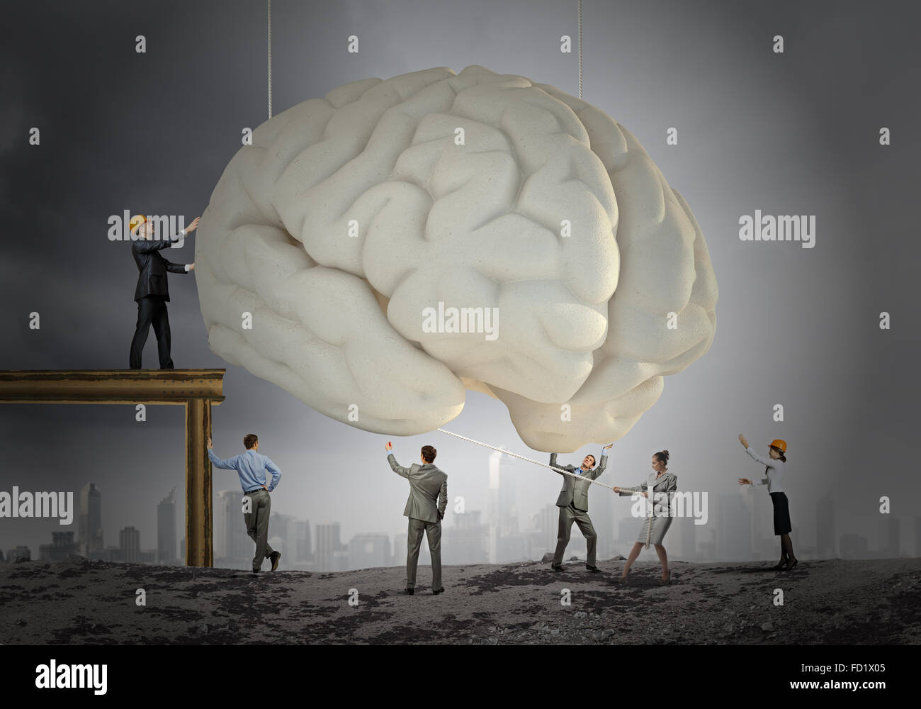 Huge human brain and many little businesspeople around Stock Photo - Alamy