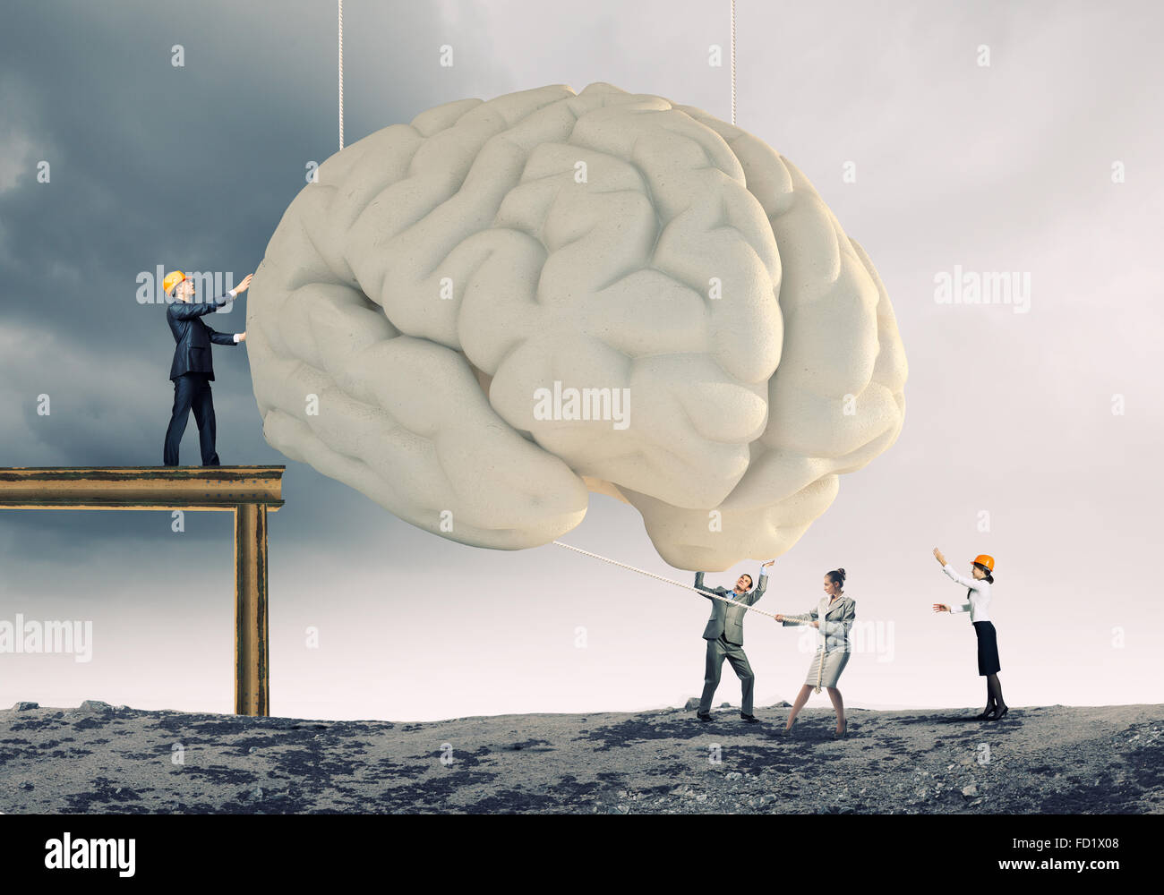 Huge human brain and many little businesspeople around Stock Photo - Alamy