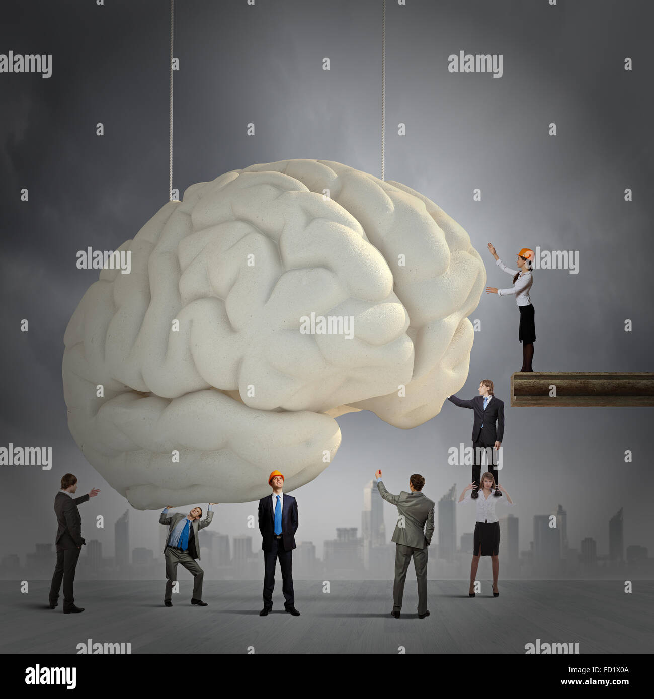 Huge human brain and many little businesspeople around Stock Photo - Alamy