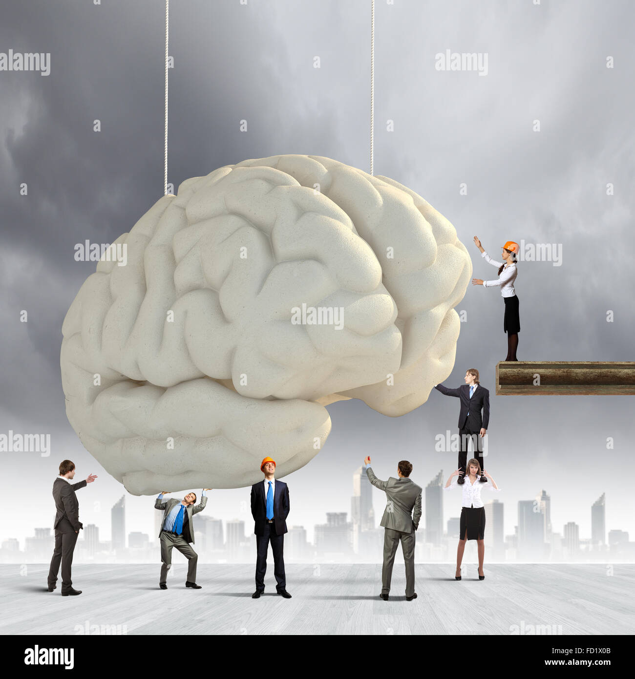 Huge human brain and many little businesspeople around Stock Photo - Alamy