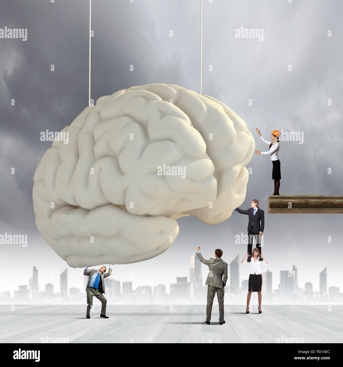 Huge human brain and many little businesspeople around Stock Photo - Alamy