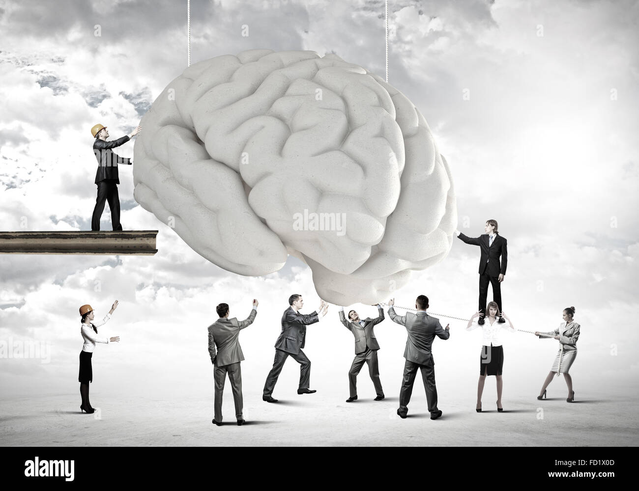 Huge human brain and many little businesspeople around Stock Photo - Alamy